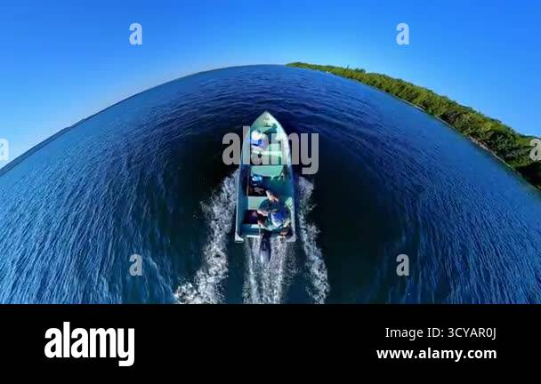 Fishing boat gliding at inland lake of Manitoulin Island. Water sport ...