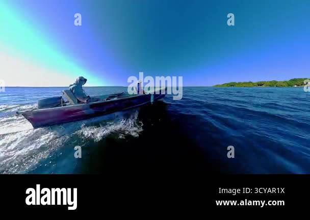 Fishing boat gliding at inland lake of Manitoulin Island. Water sport ...