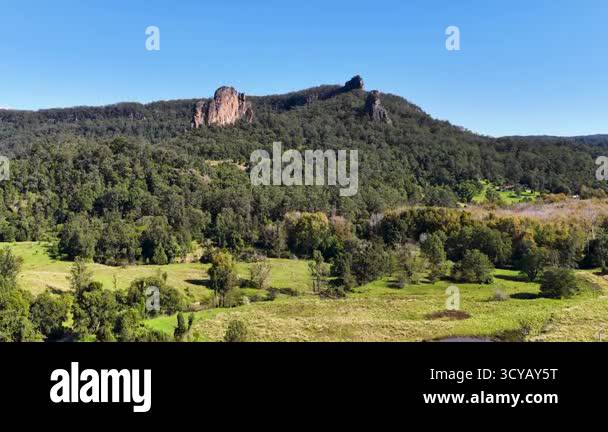 Panoramic view of Nimbin Rocks under clear blue skies, showcasing lush ...
