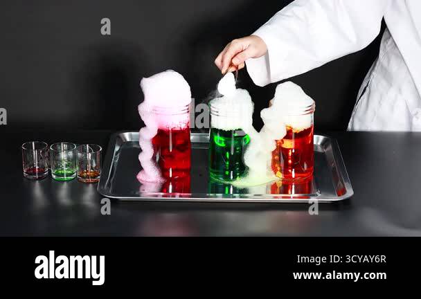 Colorful foam erupts from beakers with dry ice Stock Video Footage - Alamy