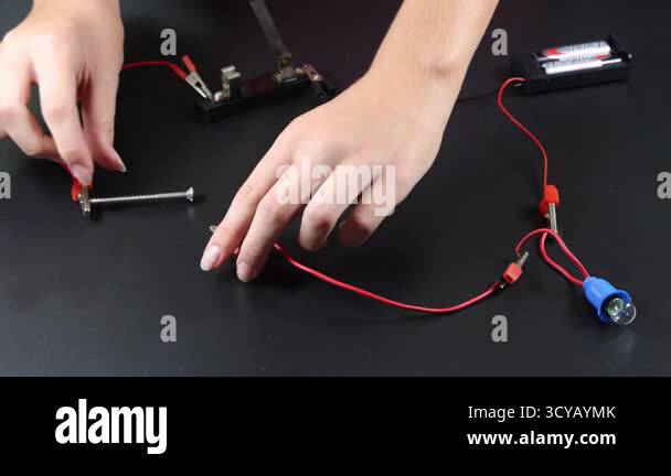 Hands-on experiment with electric circuits and materials Stock Video ...
