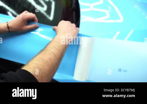 Applying PPF wrap on car during full detailing 4k video. Bold blue ...