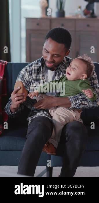 Peaceful young daddy calming up beautiful baby little boy crying in the ...