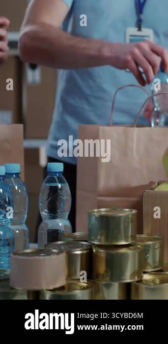 Female volunteer preparing free food delivery for poor people. As ...