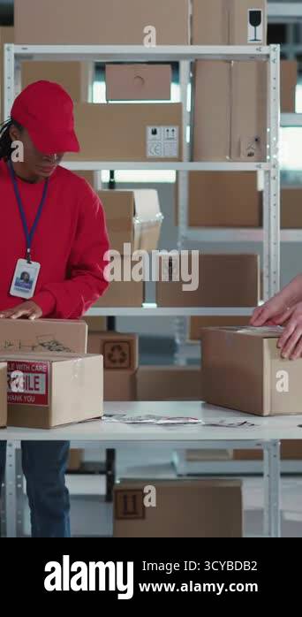 Cooperative Multi-Race Young Couple of Workers Wearing Red Professional ...