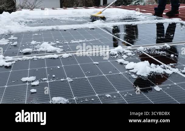 Snow removal from solar panels in winter.Cleaning Snow off Solar Panel ...