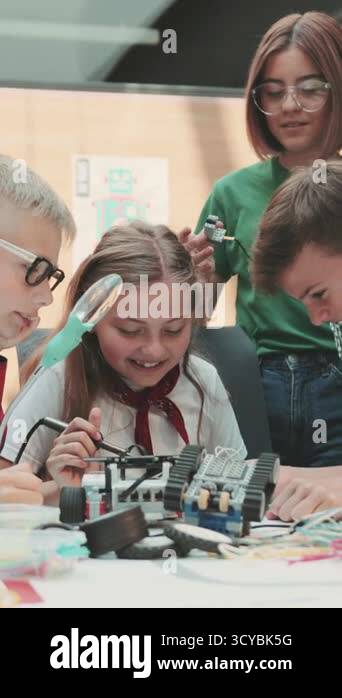 A team of children is working in the office. Discuss new toy ...