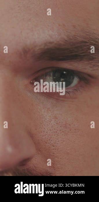 Close up of a male eye. Detail of a green eye of a man looking around ...
