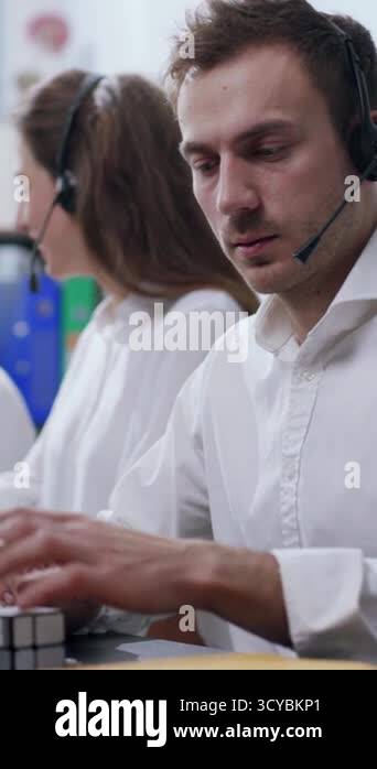 Two dedicated call center agents are actively engaged in their work ...