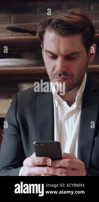 A sharp businessman dressed in an elegant suit is intently focused on ...