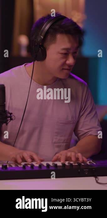 This video shows a musician in a studio, playing a keyboard and singing ...