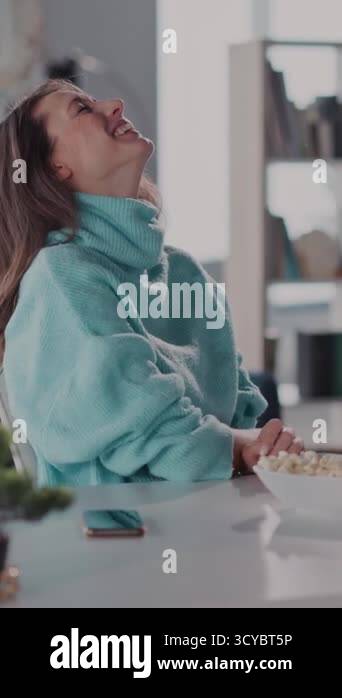 This video shows a woman in a cozy blue sweater at home, focusing on ...