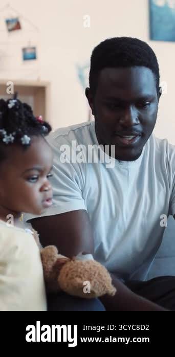 A heartfelt moment shared between a devoted father and his loving daughter, showcasing their ...