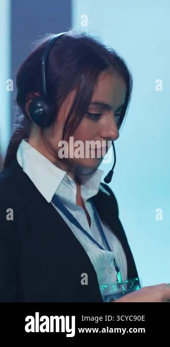 A focused businesswoman in a headset is engaged in effective ...