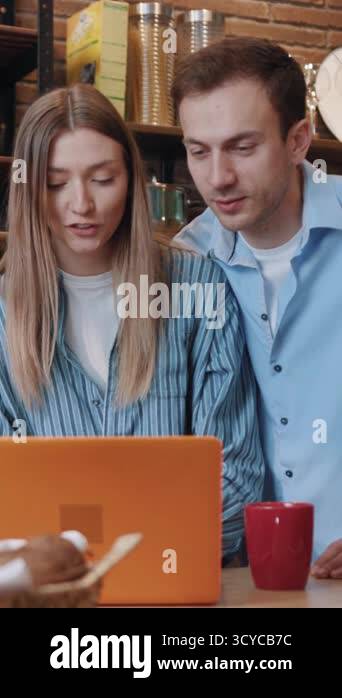 Husband and wife couple sharing a computer laptop social network ...