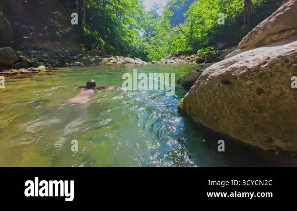 Aerial video of a scenic waterfall cascading down a rocky mountain ...