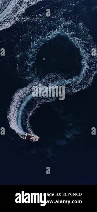 Aerial top down drone view of a speedboat forming an infinity loop on ...