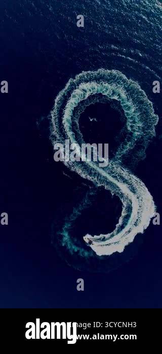 Aerial top down drone view of a speedboat forming an infinity loop on ...
