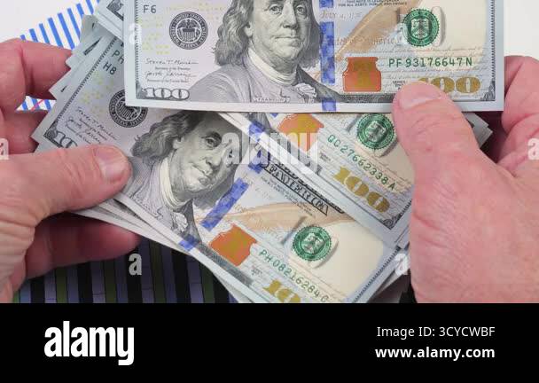 Hands of an elderly financier slowly shift money, dollars. Slow motion ...