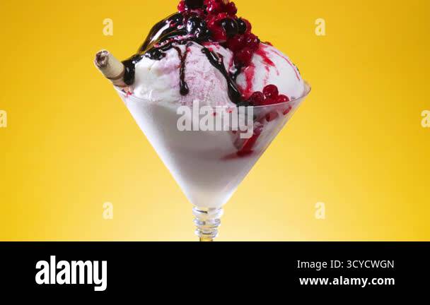 Sweet ice cream in a metal, silver container slowly rotates around its ...