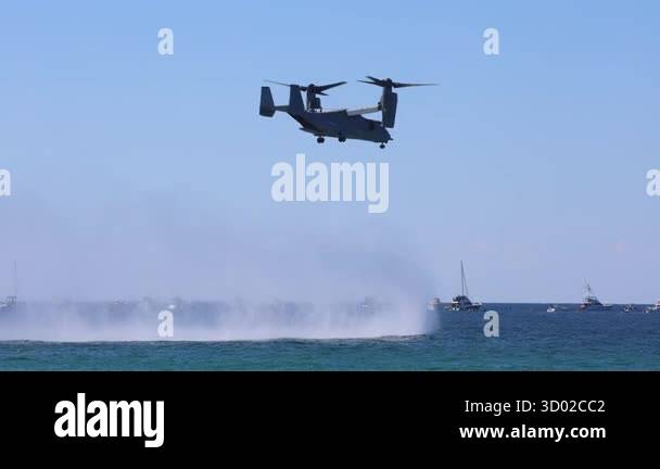 Helicopter flying over ocean near naval ship Stock Video Footage - Alamy
