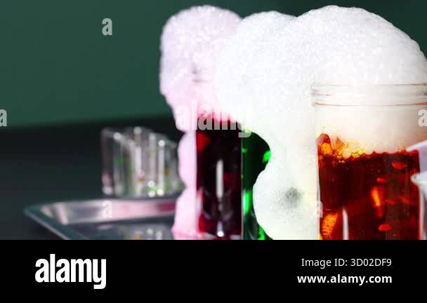 A vibrant science experiment with dry ice creating colorful bubbling ...