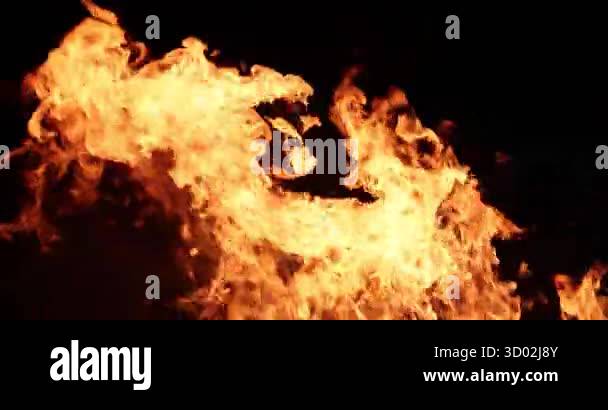 Flames twist and turn in a mesmerizing display against the darkness ...