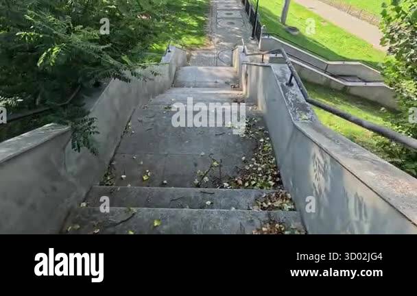 Calm POV shot of a person walking down the stairs and continuing along ...