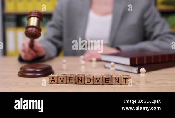 A person holds a gavel while emphasizing the word amendment ...
