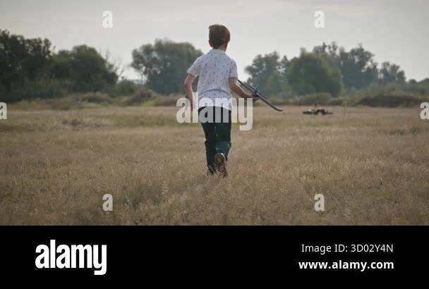 Man and Boy Play with Toy Airplane on Field. Dad and Child Spend Time ...