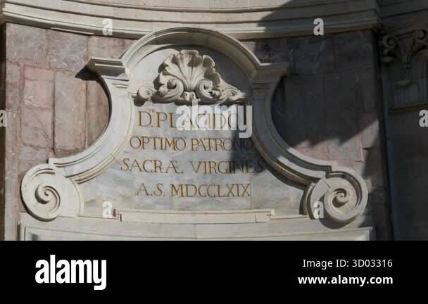 Close up of ancient Latin inscription with golden letters on marble ...