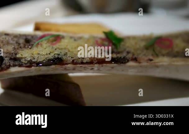 roasted beef marrow bone elegantly presented on a white plate rich and ...