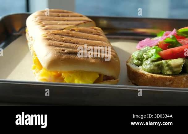 on a bright red plate avocado with baked lime Healthy food. Bread toast ...