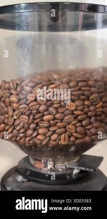 Barista pouring steamed milk into a cup to create latte art, close-up ...