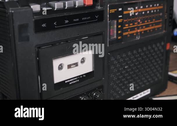 Close up shot pressing play on vintage black boombox, showing white ...