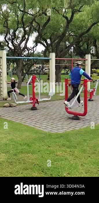 Cuenca, Ecuador: May 3 2025: Wide static shot video people exercising ...