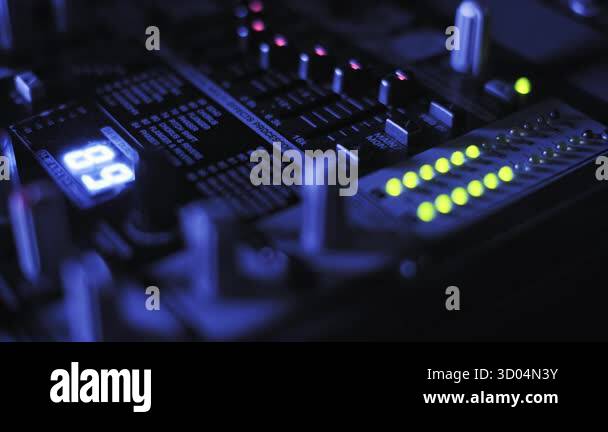 Close-up dolly shot moving toward professional audio console, showing ...