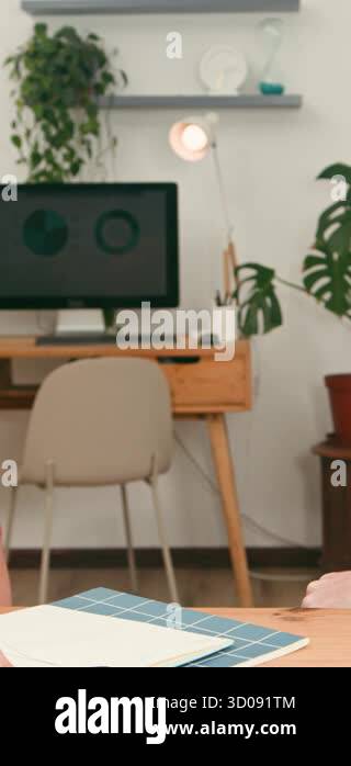 Two people exchange a friendly fist bump over an office desk with a ...