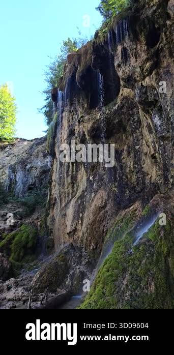 Slow motion video of Pisoaia Waterfall with green moss travertine rocks ...