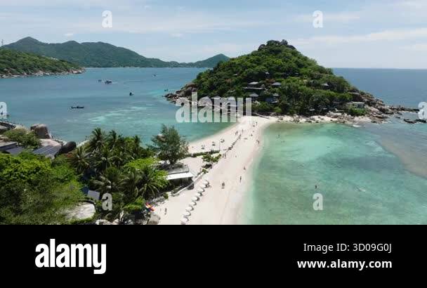 Clear turquoise waters and lush green islands with a sandy beach under ...