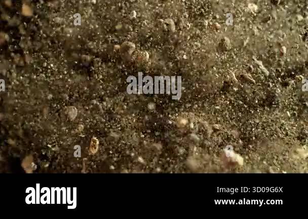 Super Slow Motion Shot of Exploding Soil with Rocks Towards Camera at ...
