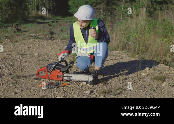 Cute woman trying to fix a chainsaw Stock Video Footage - Alamy
