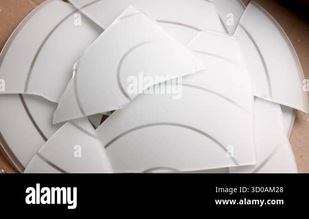 Broken lamp with glass shards in cardboard shipping box after failed ...