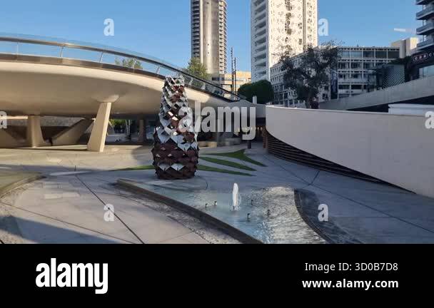 A unique public art sculpture and a dynamic fountain feature stand in a ...