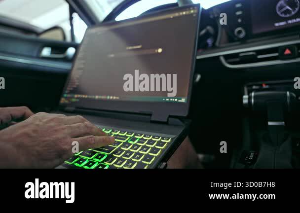 Man typing on laptop computer inside car, concept of remote work and ...