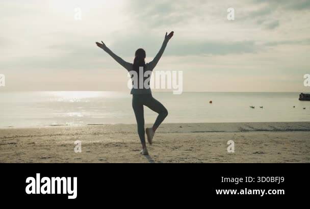 A serene dancer beautifully showcases her extraordinary balance and ...