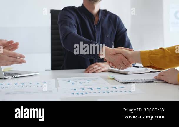 Business people partners engaging in a handshake following a successful ...