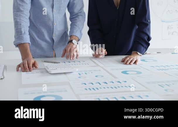 Business colleagues are working together, analyzing financial charts ...