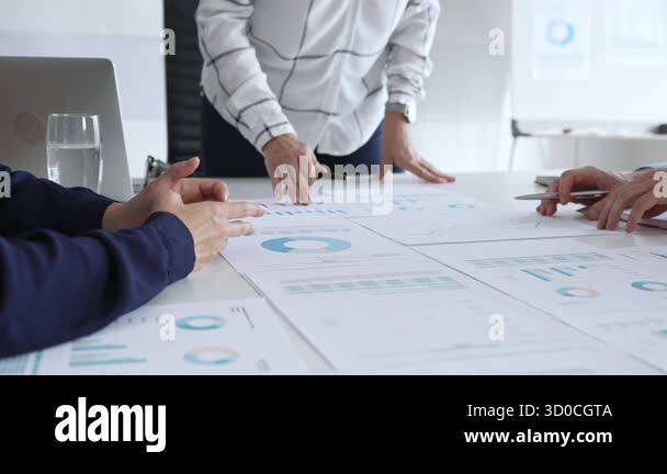 Business people team analyzing financial charts during strategy meeting ...