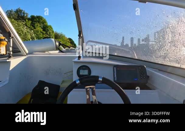 Point-of-view shot from inside an empty boat moving along a river, with ...